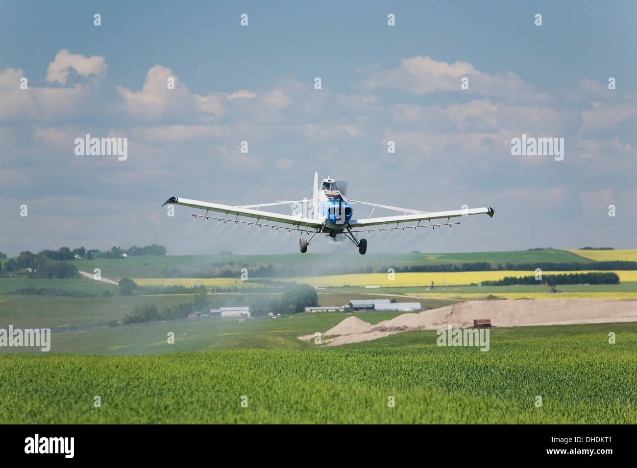 Crop Dusting Plane Over Field With Blue Sky And Clouds; Crossfield ...