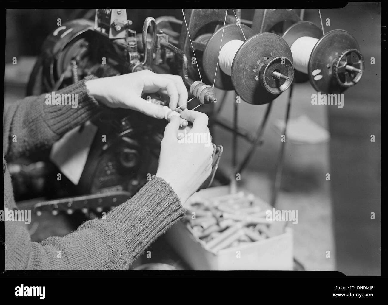A close-up photograph of a coil winder's hands at RCA Victor in Camden ...