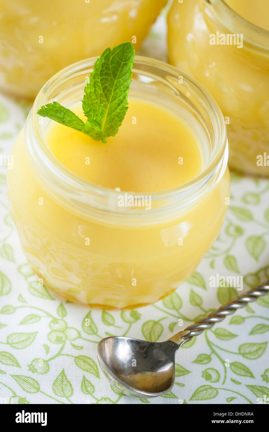 A jar of lemon curd with a spoon Stock Photo - Alamy