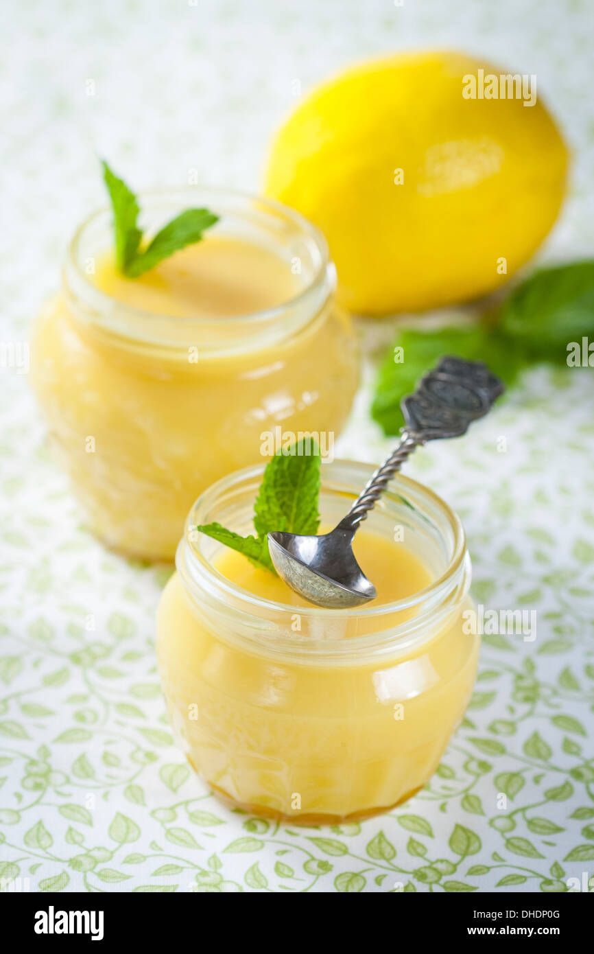 A jar of lemon curd with a spoon Stock Photo - Alamy
