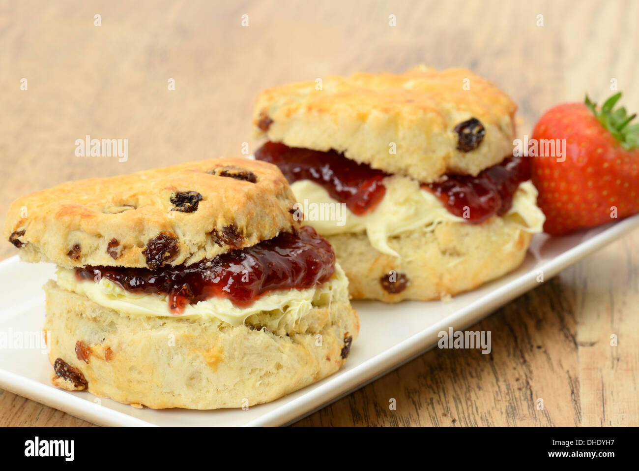 Two cream tea scones with clotted cream and strawberry jam - studio ...