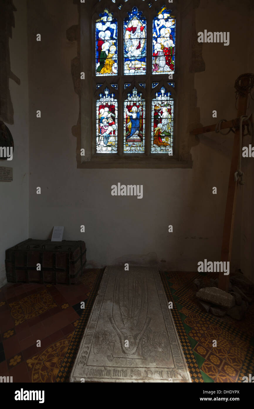 Tomb and a stained glass windows in the Priory Church of St George at ...