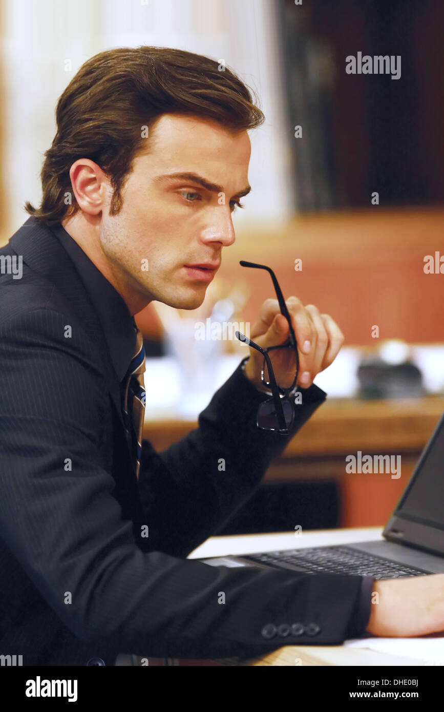Handsome businessman sits behind his office desk Stock Photo - Alamy