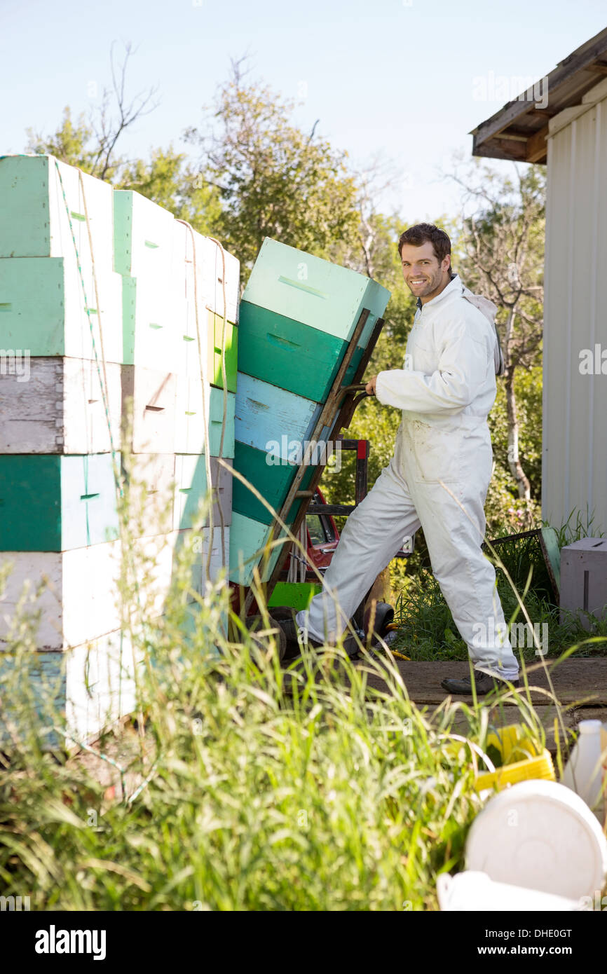Beekeeper Smiling While Loading Stacked Honeycomb Crates In Truc Stock ...