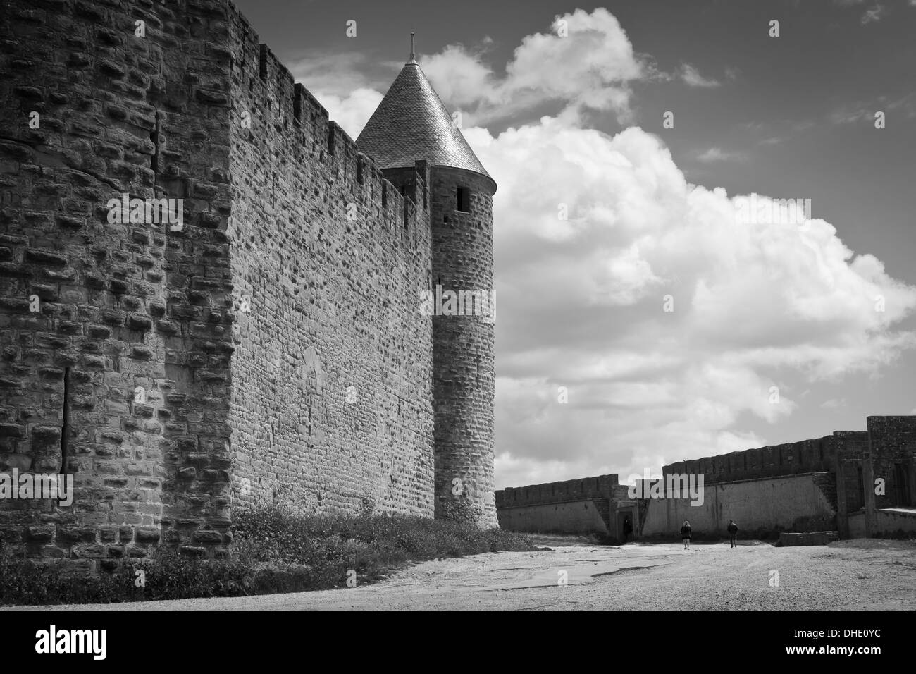 Two people walking between walls of Carcassonne Stock Photo - Alamy