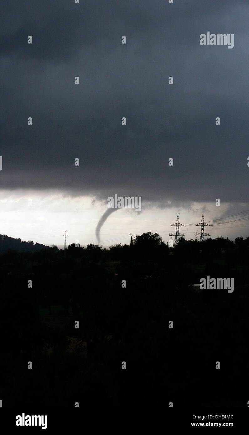 A small tornado hits the ground during a heavy storm in the Spanish ...
