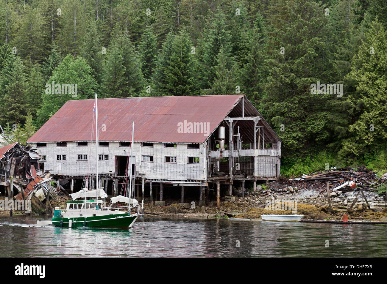 Sail boat passing the ruined cannery, Butedale, Princess Royal Island ...
