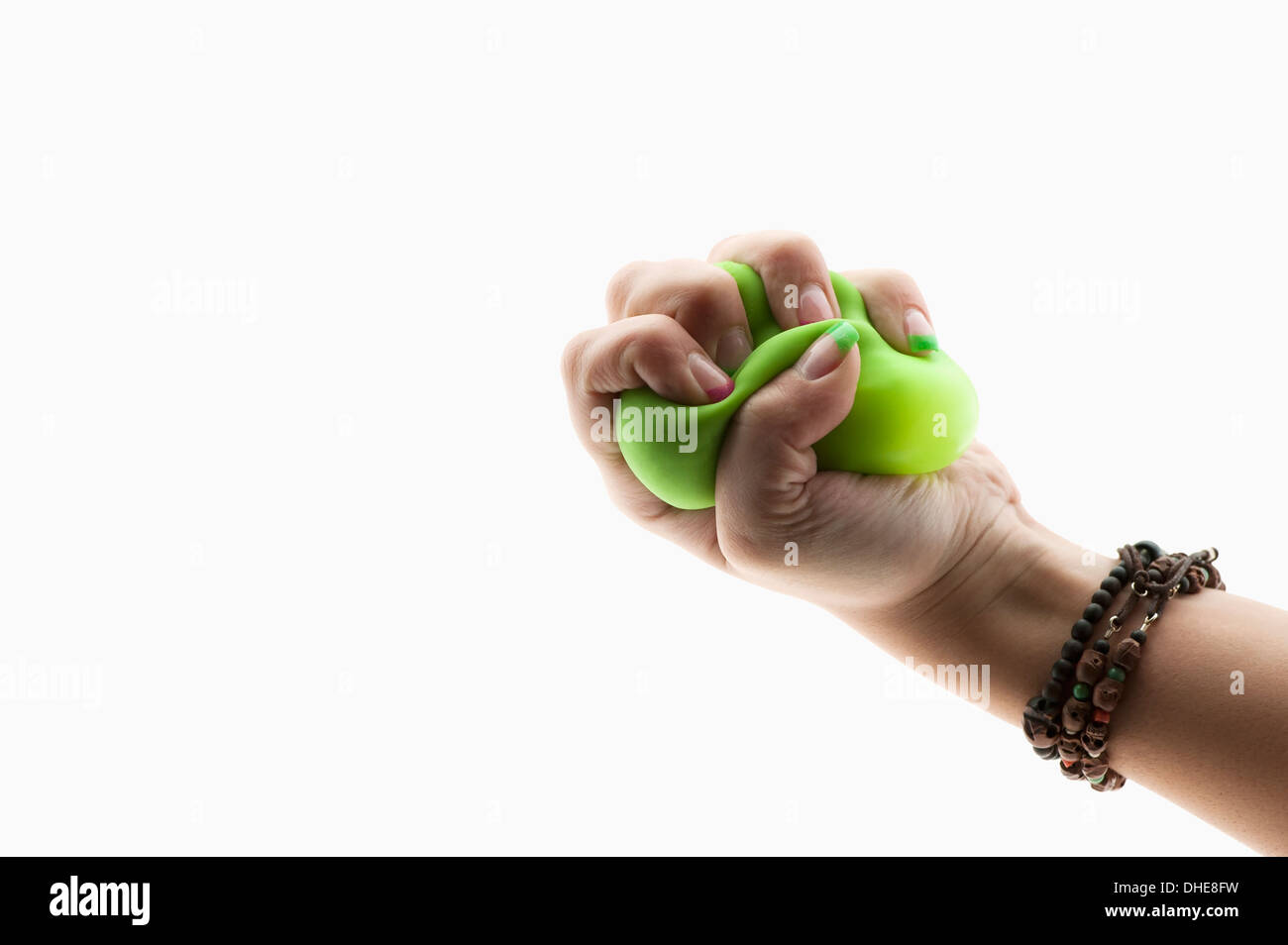 A Female Hand Squeezing A Stress Ball Against A White Background ...