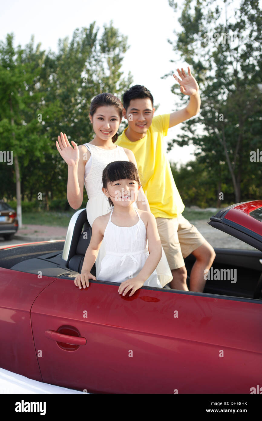 A happy family of three driving convertible cars Stock Photo - Alamy