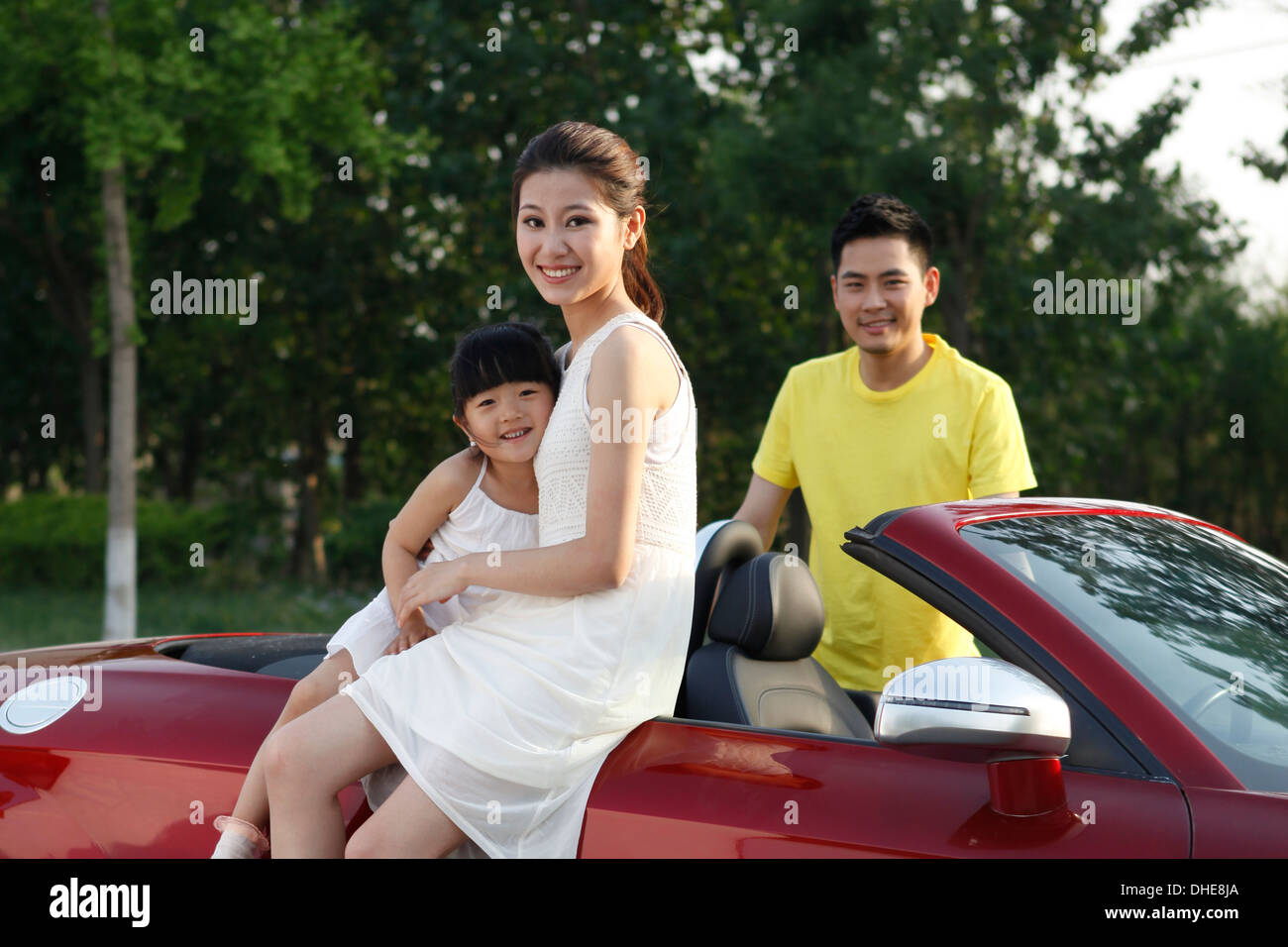 A happy family of three driving convertible cars Stock Photo - Alamy