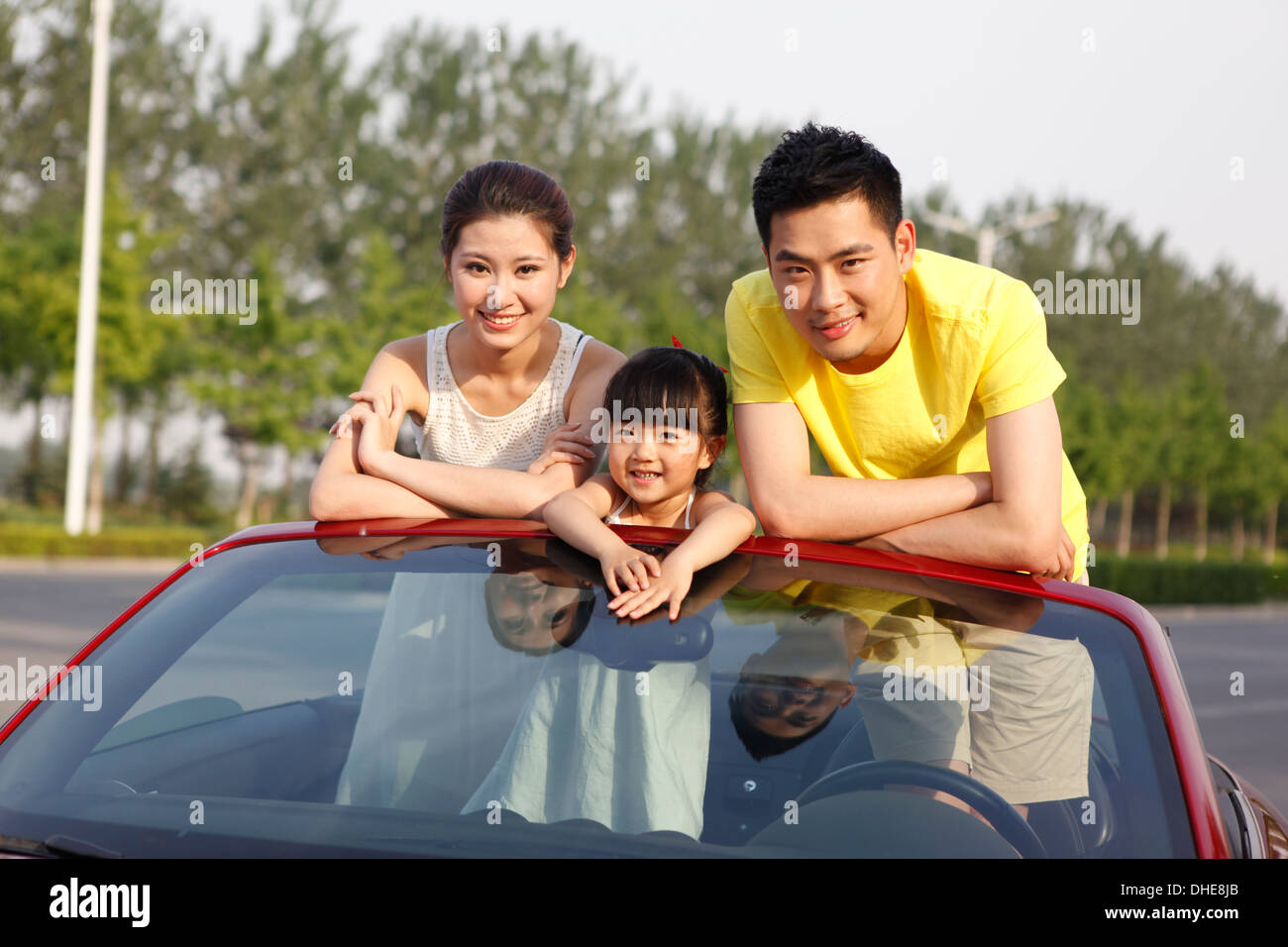 A happy family of three driving convertible cars Stock Photo - Alamy