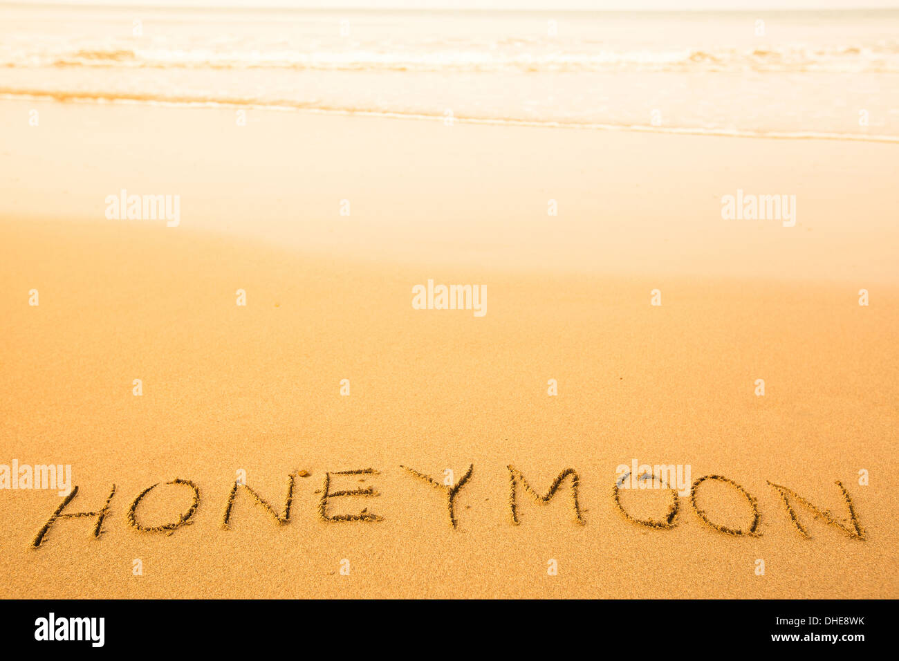 Honeymoon, text written in sand on a beach, with a soft wave Stock ...