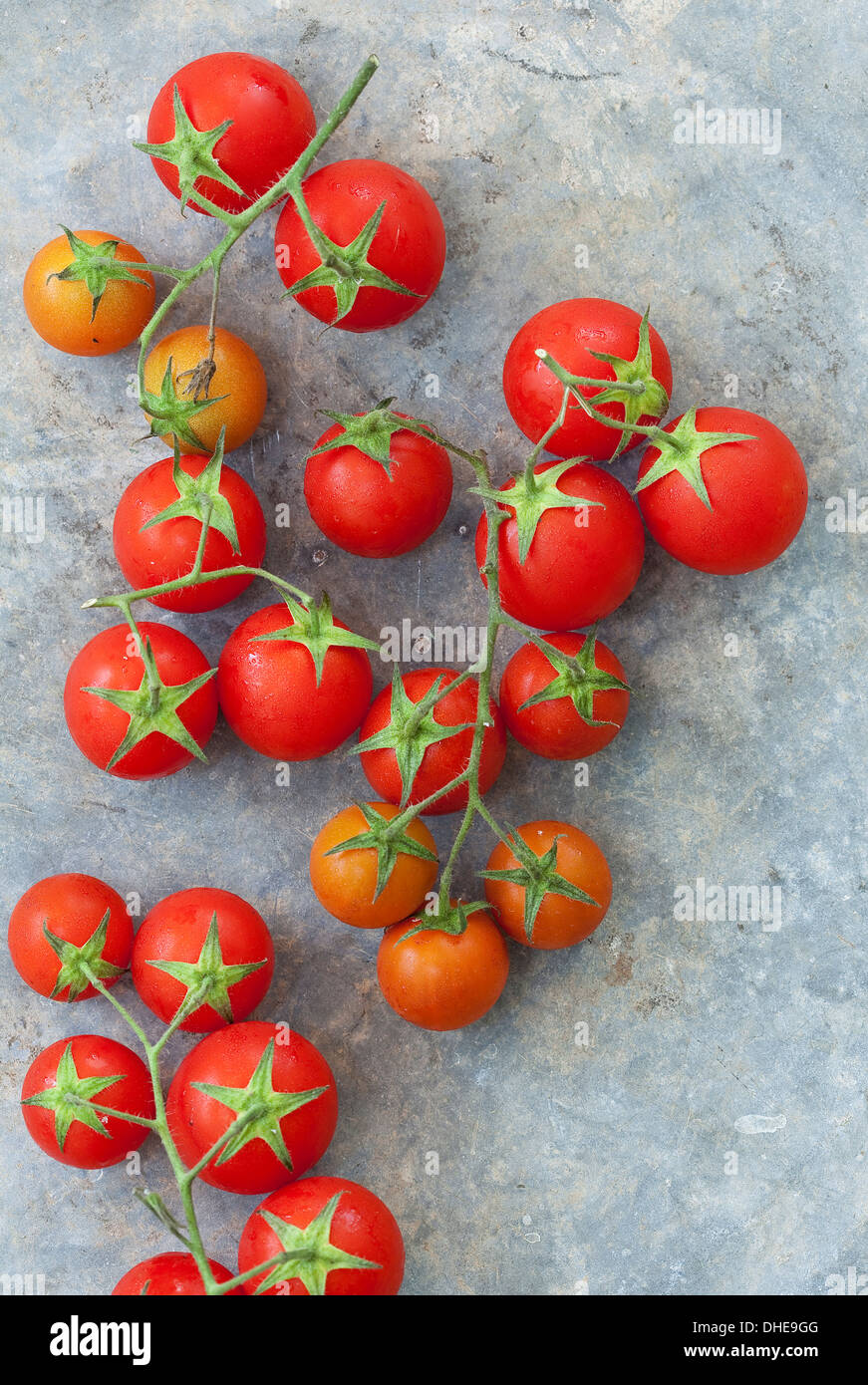 Bunches of cherry truss tomatoes on a stone surface Stock Photo - Alamy
