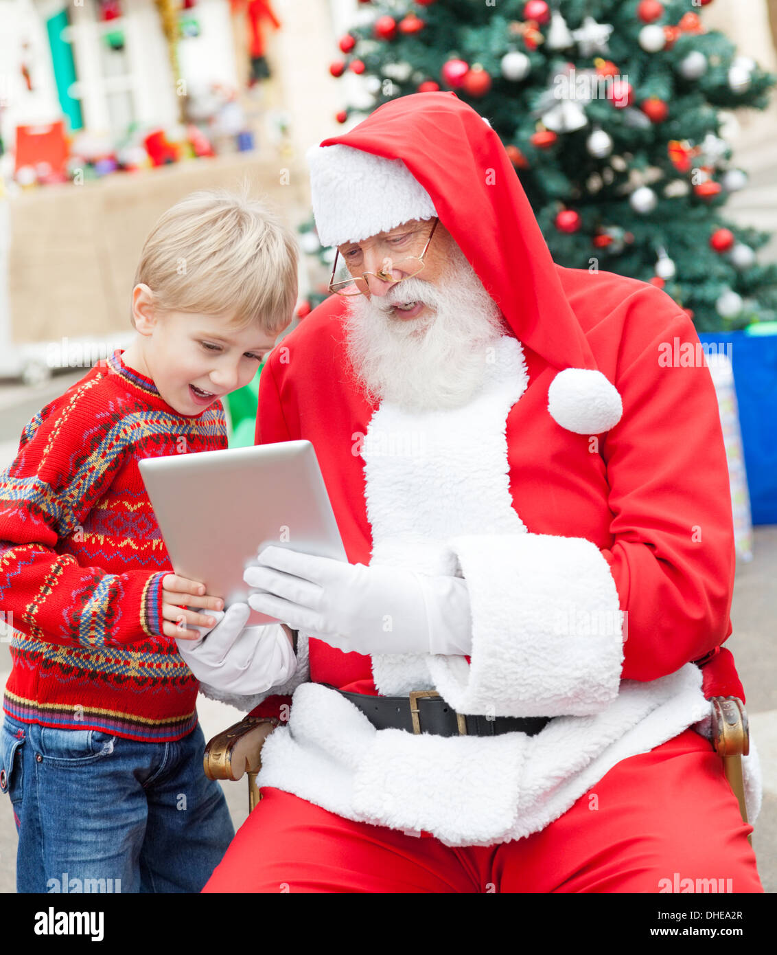 Happy santa using tablet hi-res stock photography and images - Alamy