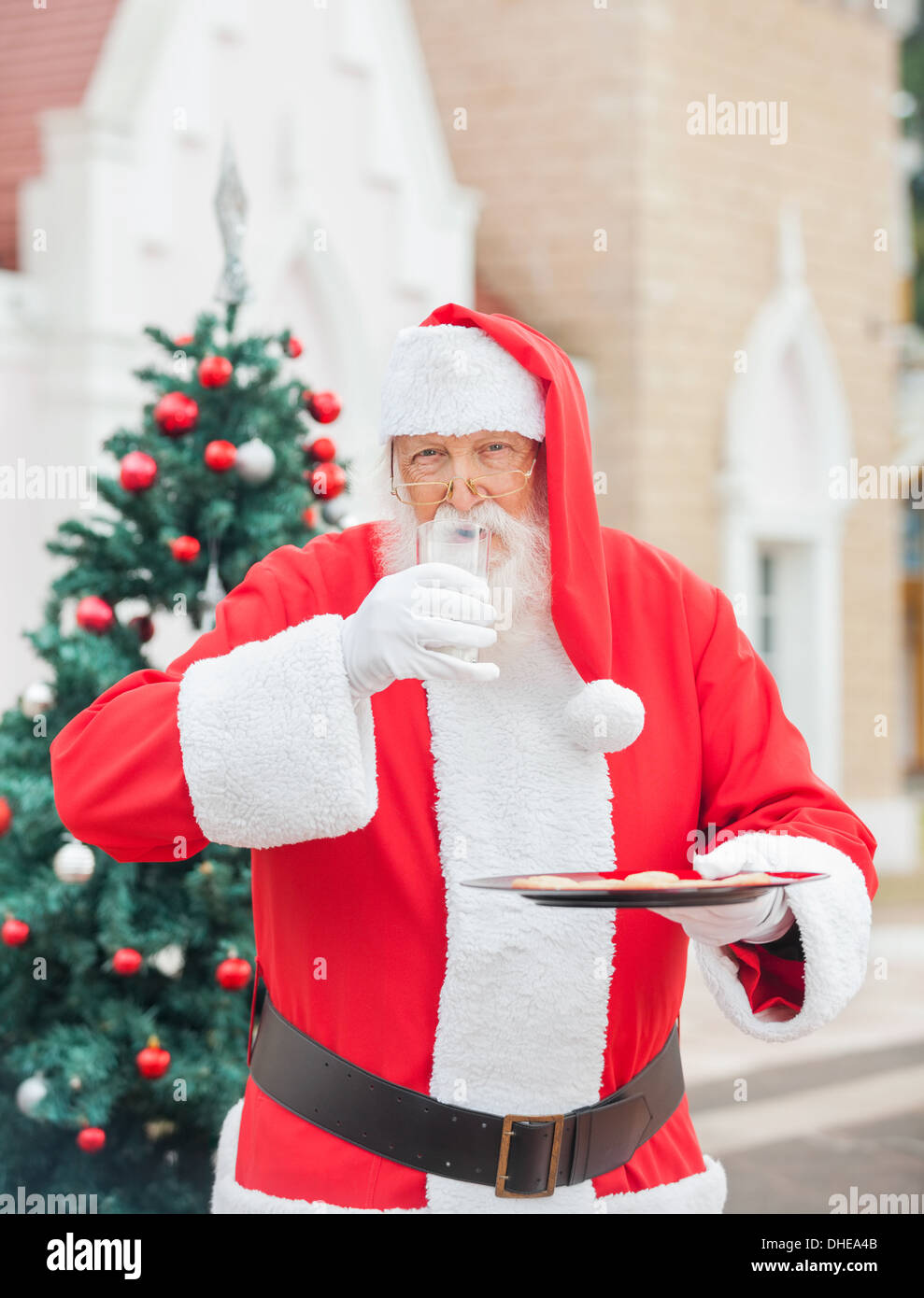 Santa Claus With Cookies Drinking Milk Stock Photo - Alamy