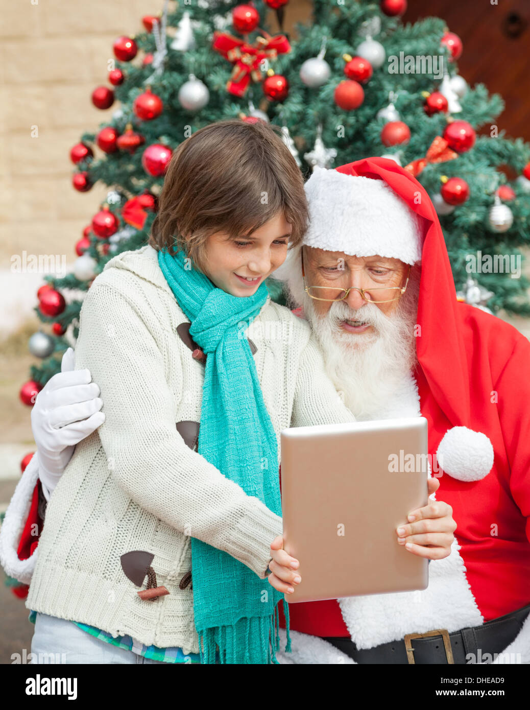 Senior santa showing pc tablet hi-res stock photography and images - Alamy