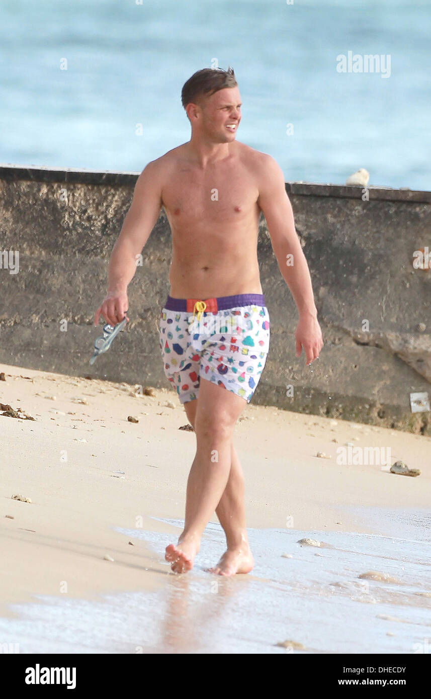 Jeff Brazier takes a walk along a beach and prepares to go for a swim ...