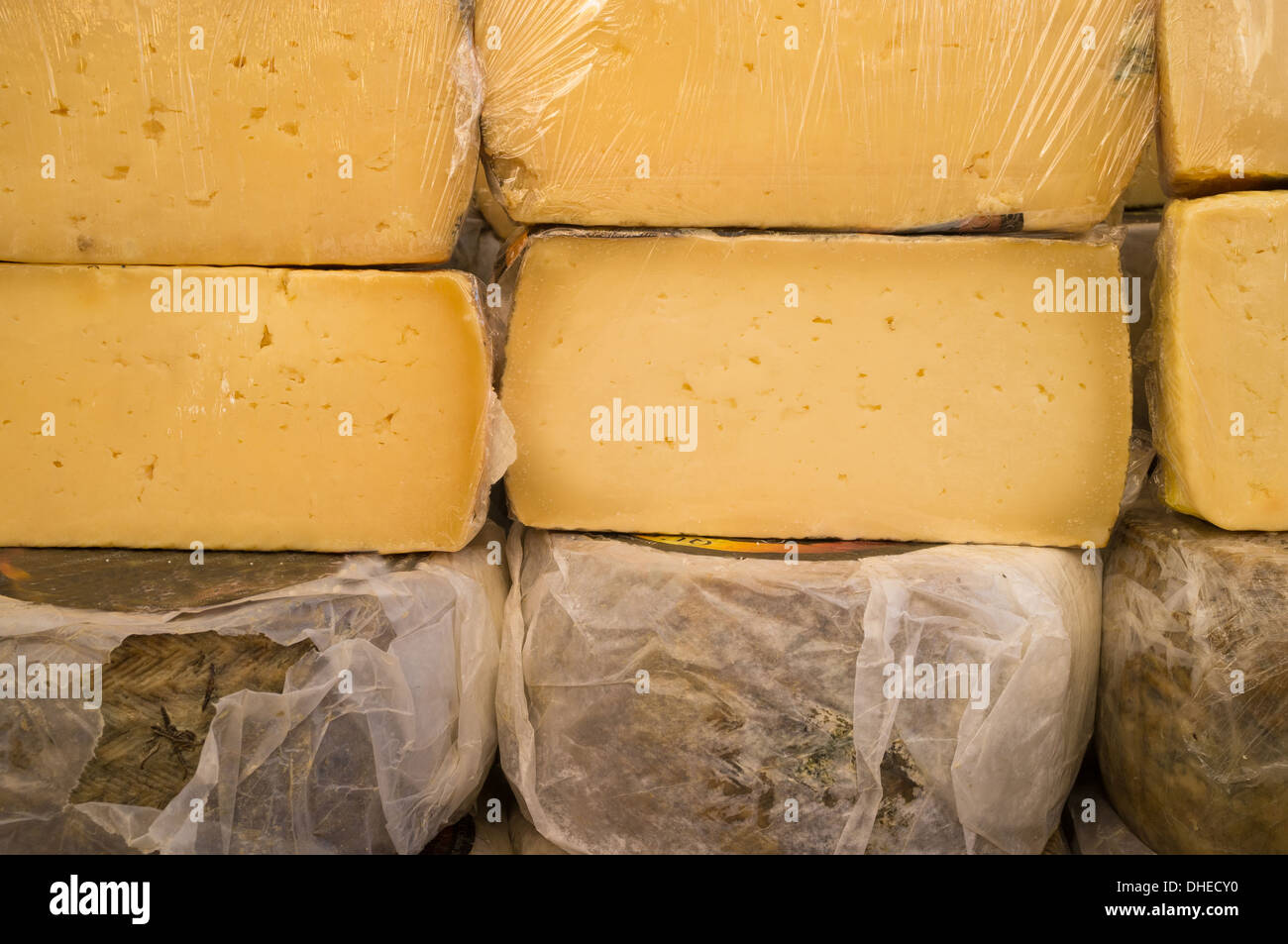 Wedges of Spanish manchego cheese piled up at a market stall Stock ...