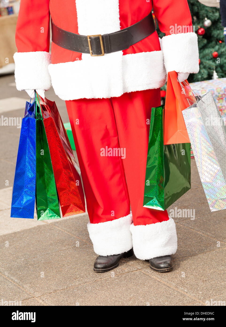 Santa Claus Carrying Shopping Bags Stock Photo - Alamy
