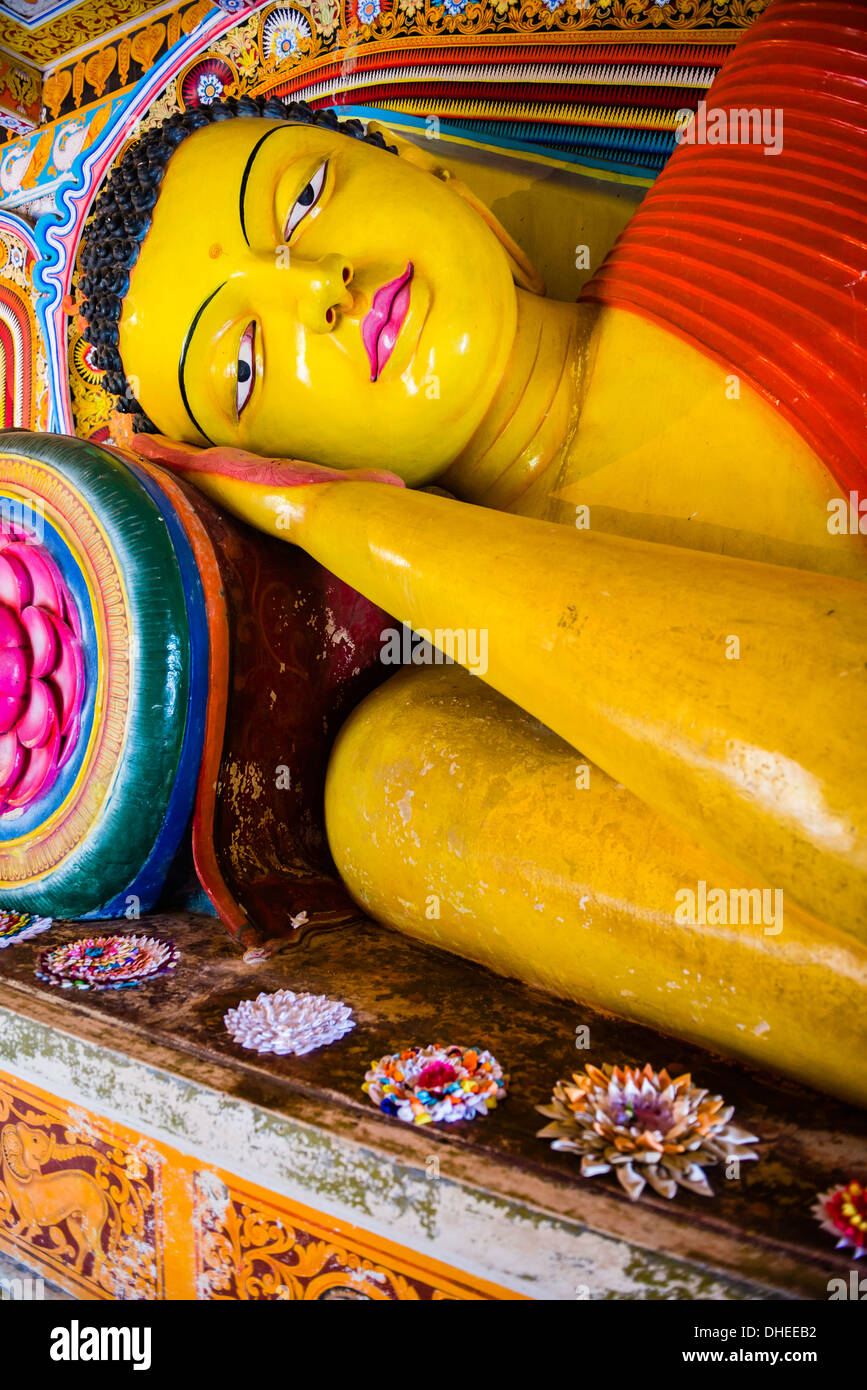 Colourful reclining Buddha statue at Isurumuniya Vihara, Anuradhapura ...