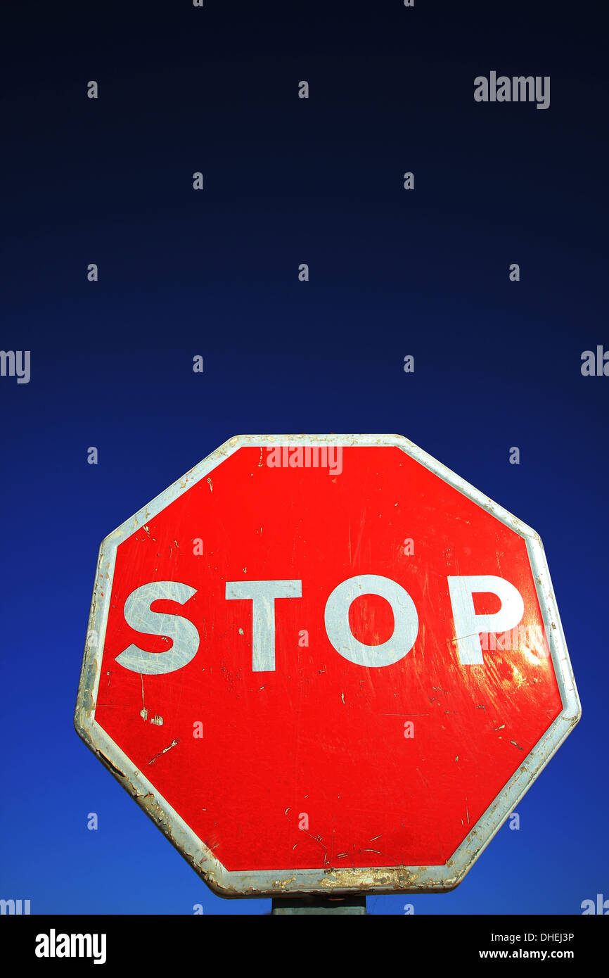 Red Stop Sign with blue background Stock Photo - Alamy