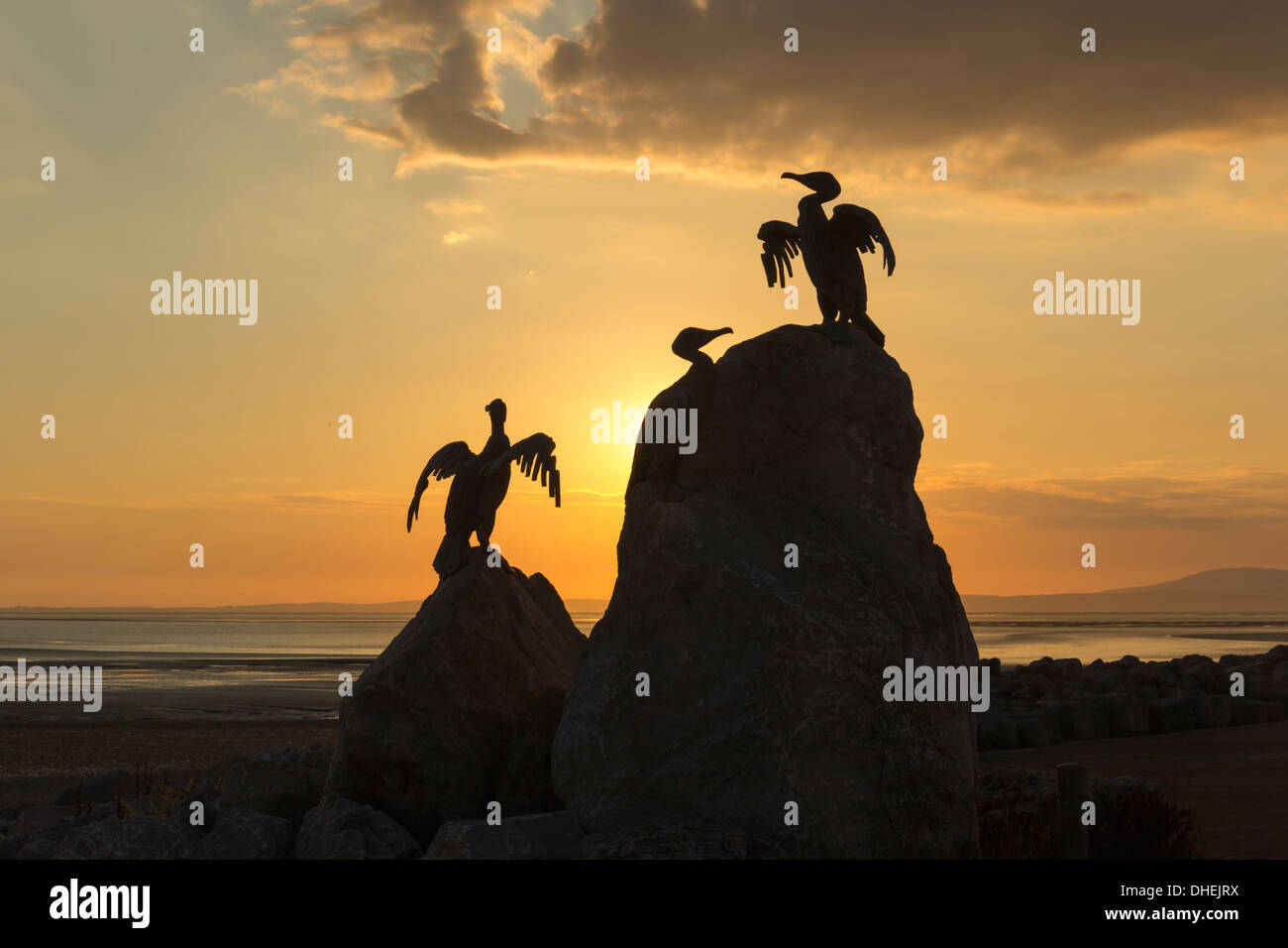 Cormorant statues on the seafront in Morecambe, Lancashire, silhouetted ...