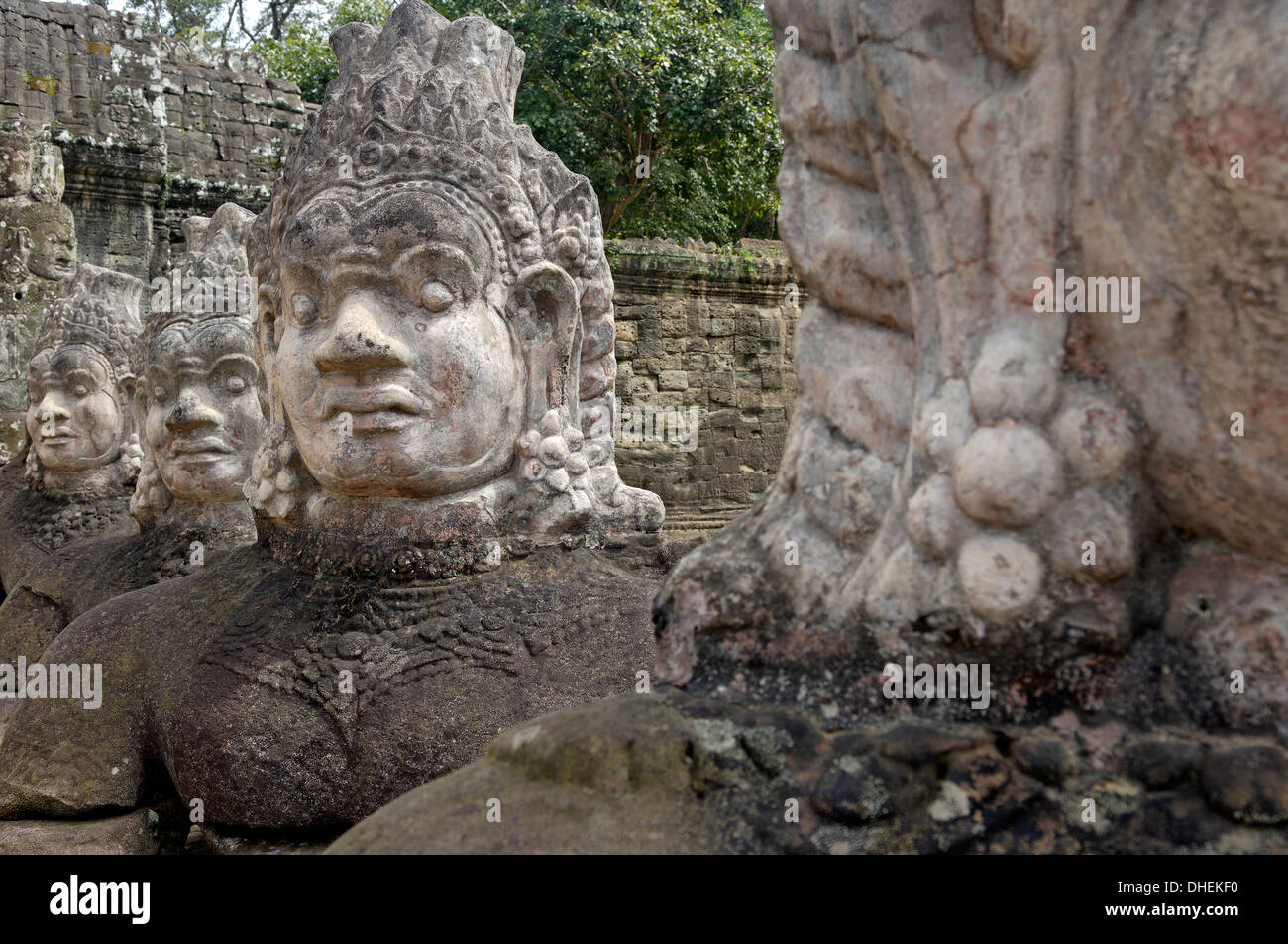 Southern causeway of Angkor Thom, flanked by gods holding scaly body of ...