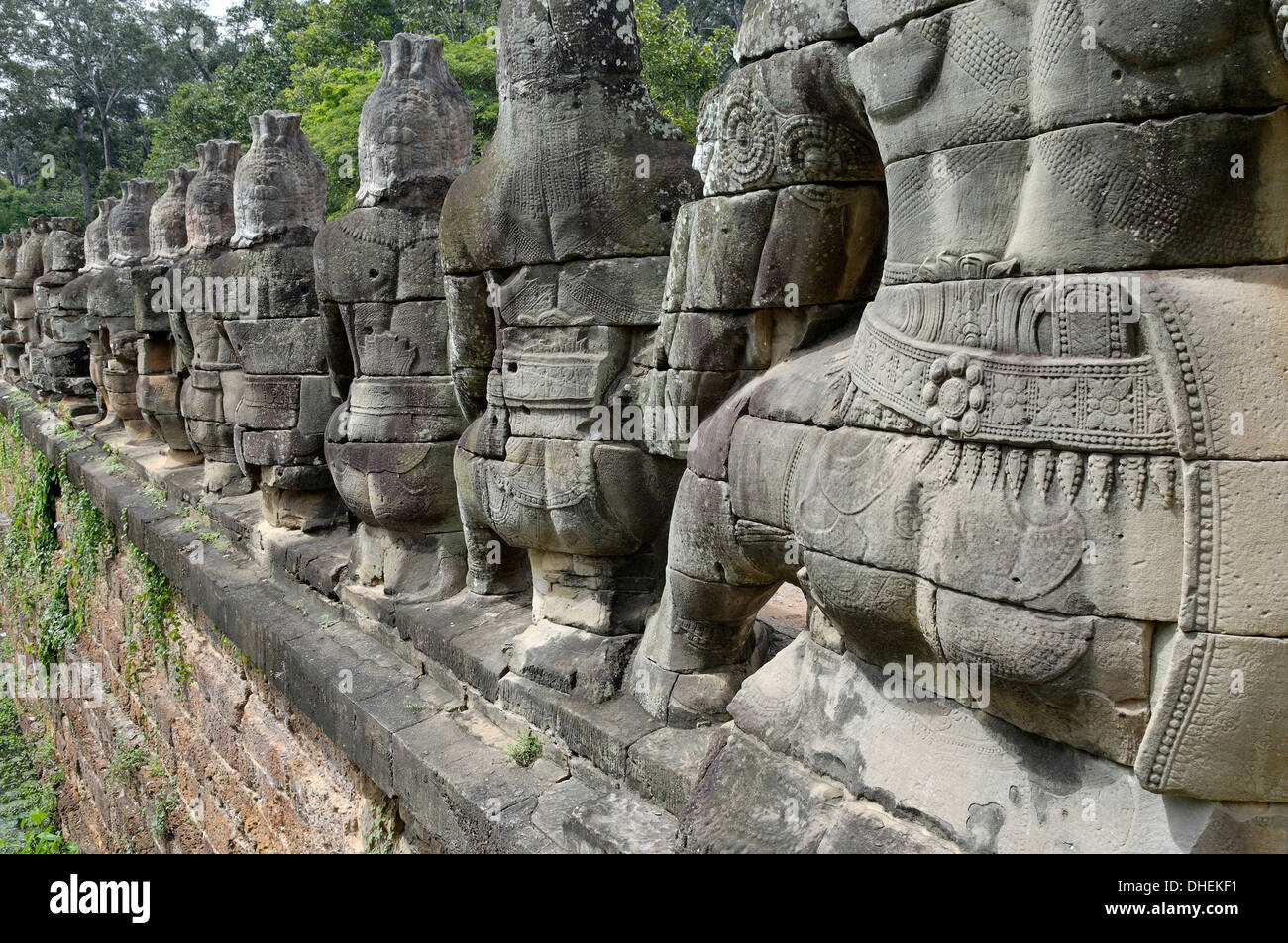 Southern causeway of Angkor Thom, flanked by gods holding scaly body of ...