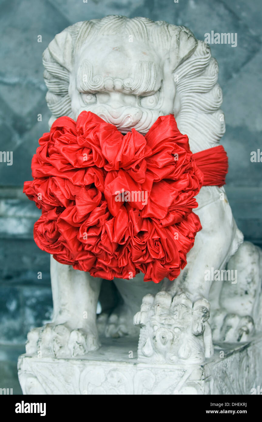 A lion statue decorated in red ribbon, Beijing, China, Asia Stock Photo ...