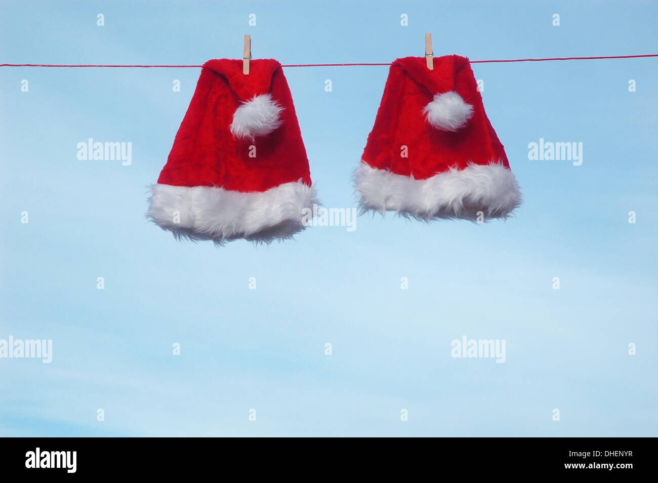 Illustration - Two Santa Claus hats are pictured on a clothesline, 28 ...