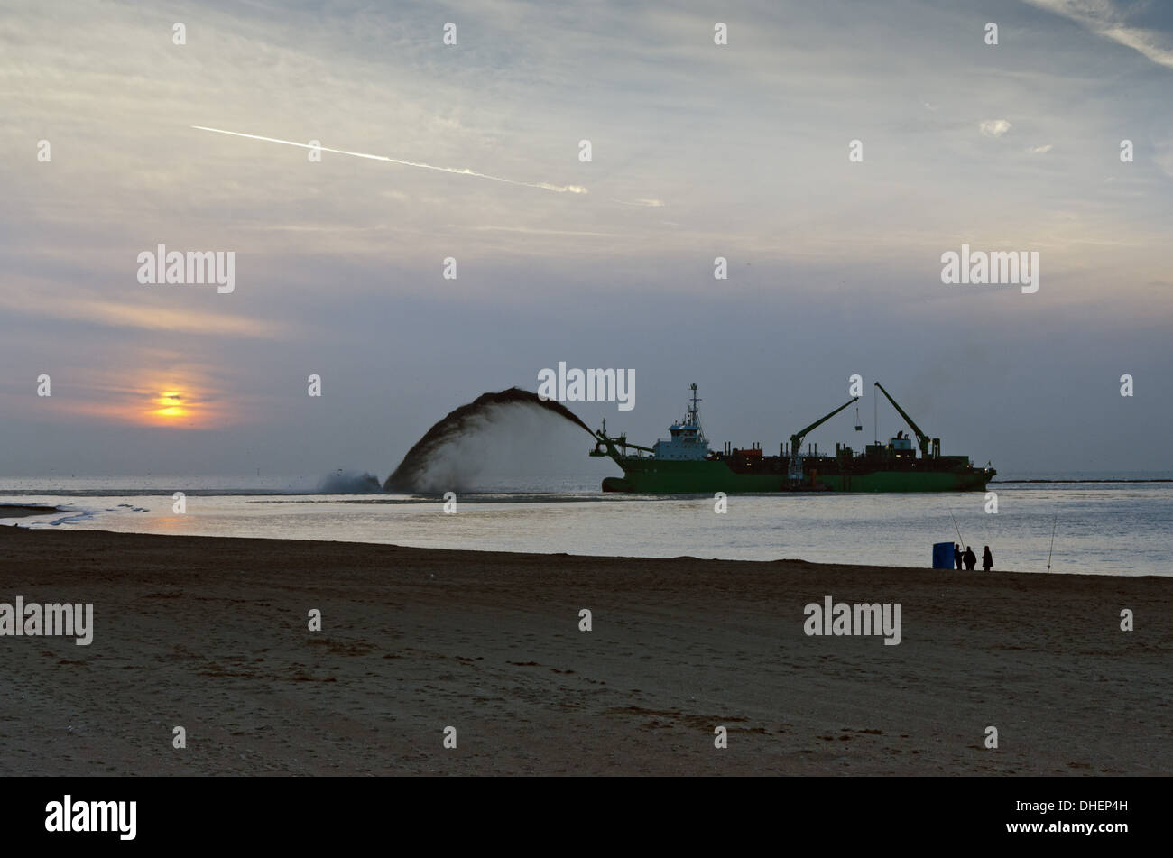 Sand-throwing ship laying down. At sunset on the coast of Ostend Stock ...