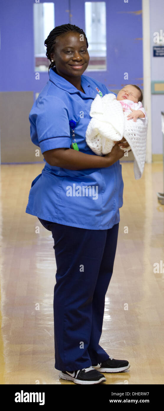 A midwife holds a newborn baby in a hospital corridor UK Stock Photo ...