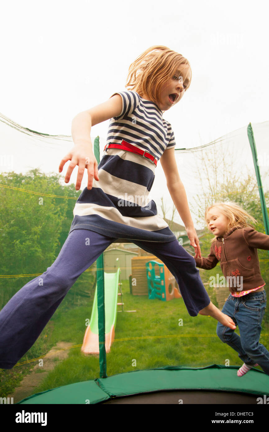 Girls jumping on trampoline Stock Photo - Alamy