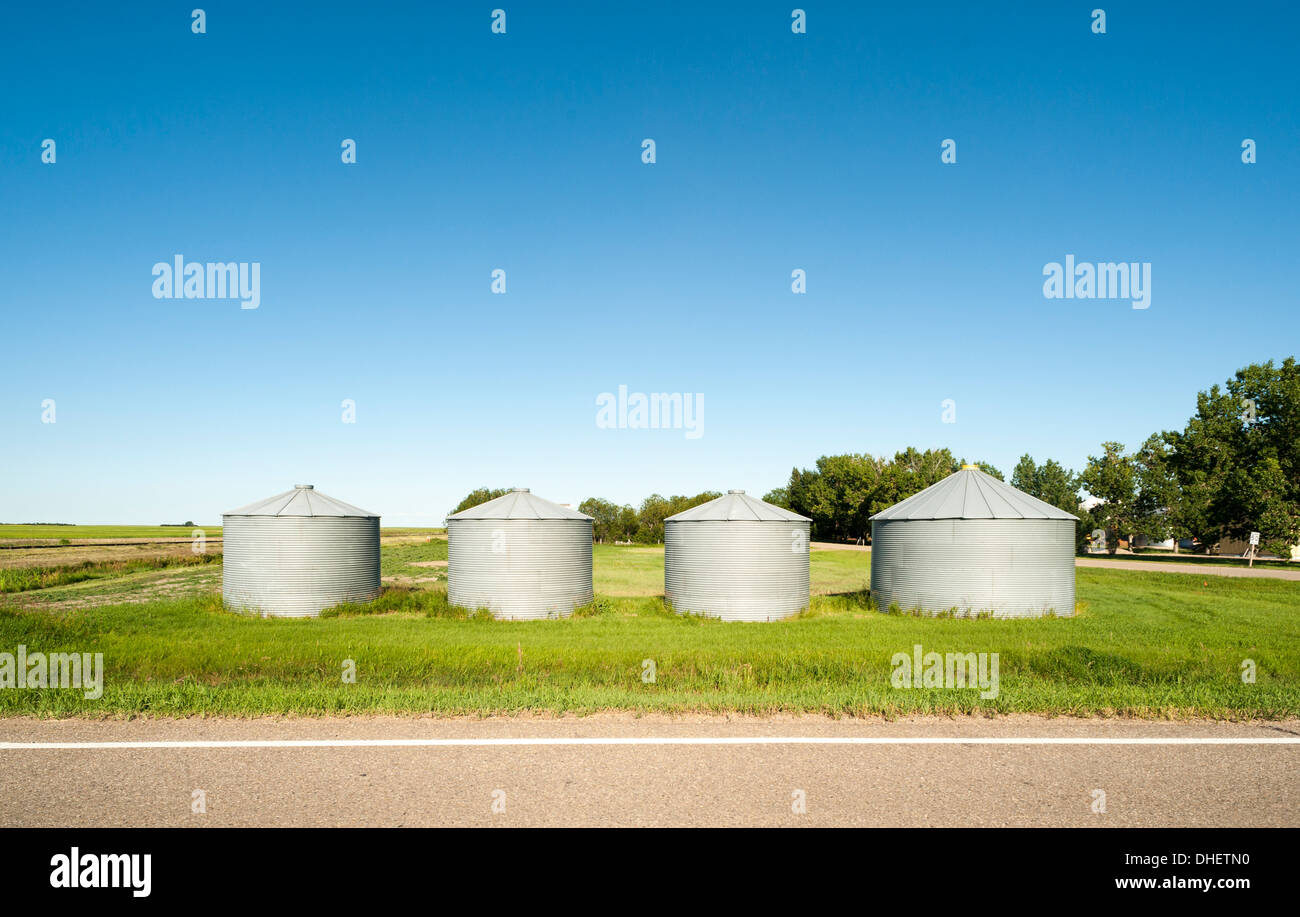 Four grain silos on an empty road Stock Photo - Alamy