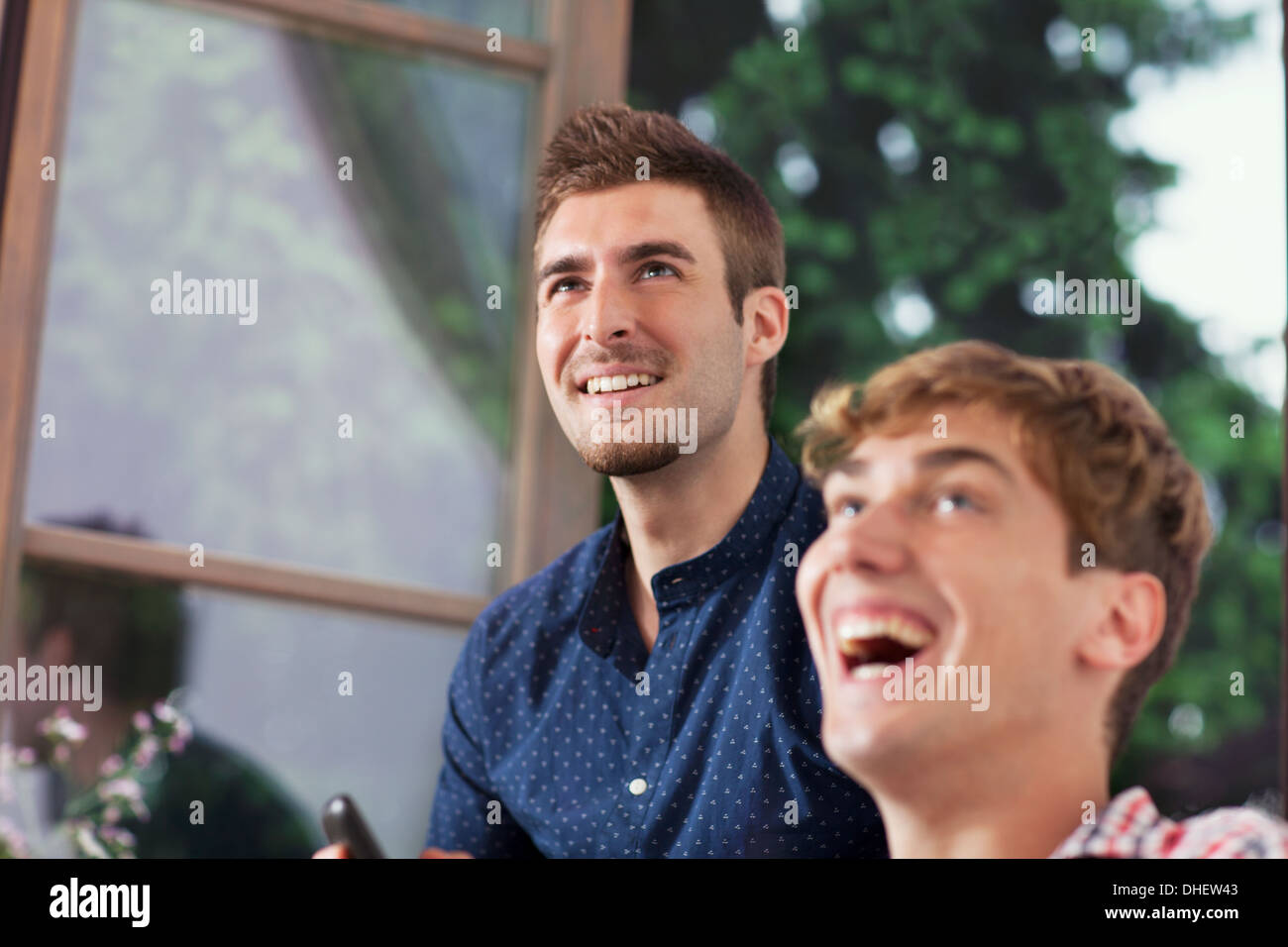 Two young men laughing Stock Photo - Alamy
