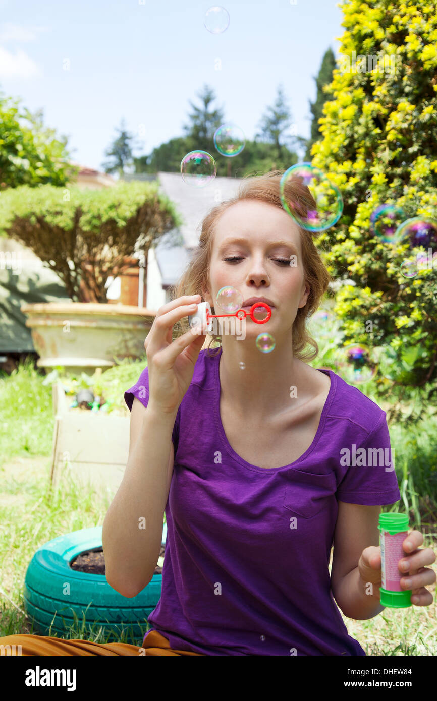 Woman blowing bubble in garden hi-res stock photography and images - Alamy