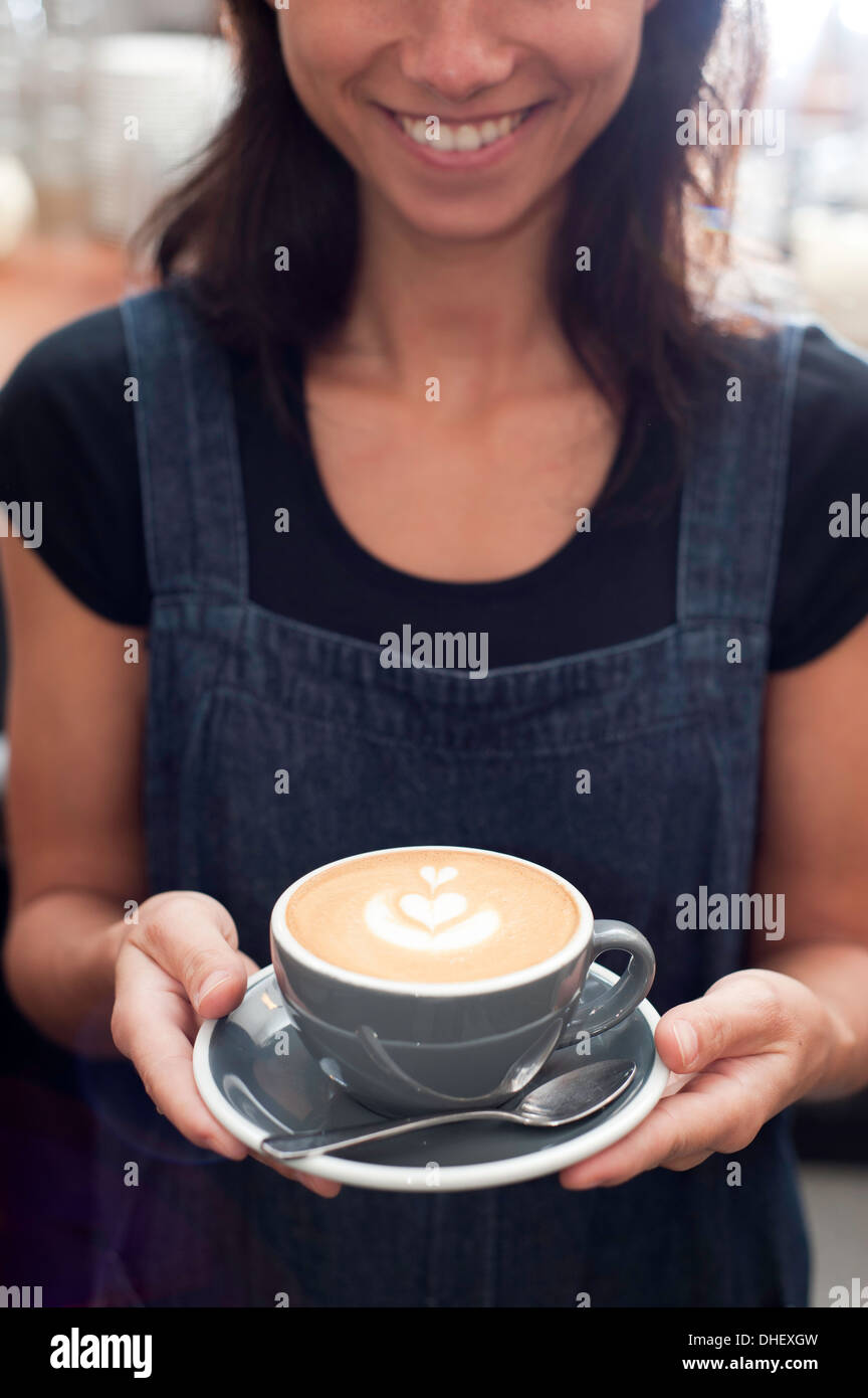 Barista serving cappuccino Stock Photo - Alamy