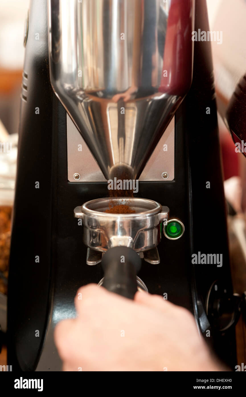 Barista collecting ground coffee Stock Photo - Alamy