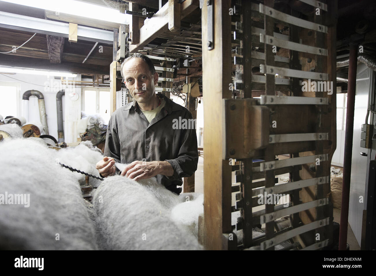 Worker with fleece in wool factory Stock Photo - Alamy