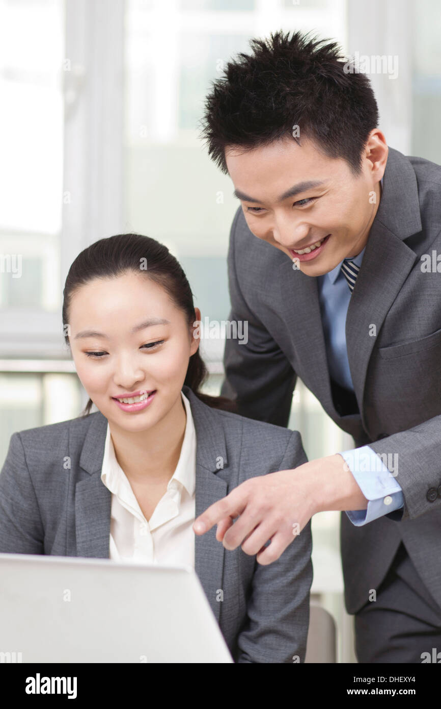 Group of businesspeople discussing,working on computer Stock Photo - Alamy