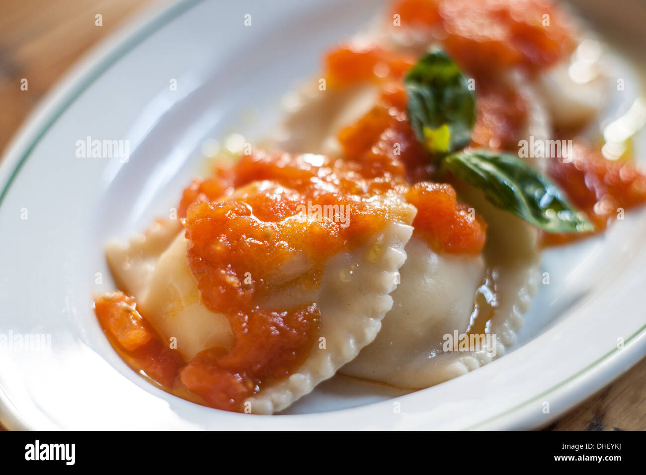 Still life with ravioli, tomato sauce and basil garnish Stock Photo - Alamy