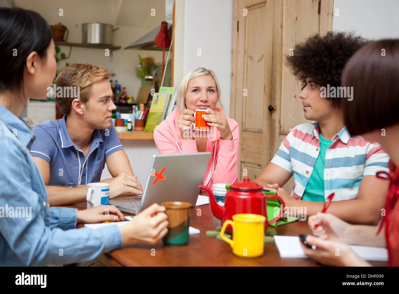 Young adults sitting around table hi-res stock photography and images ...