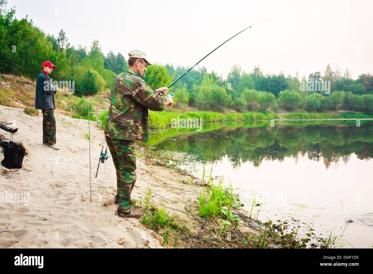 Belorussian fisherman catches a fish in the river at the bait Stock ...