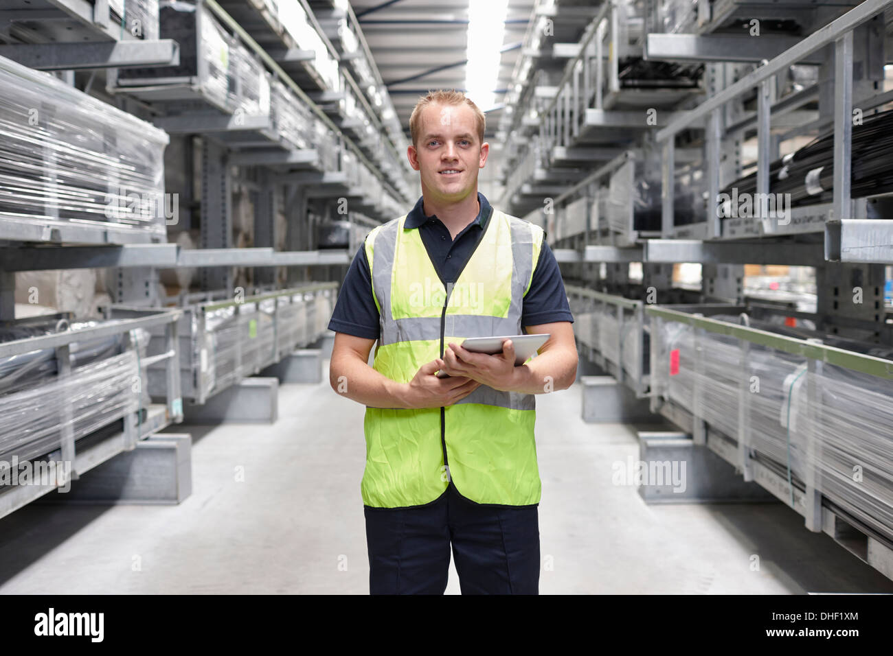 Portrait of worker in engineering warehouse Stock Photo - Alamy