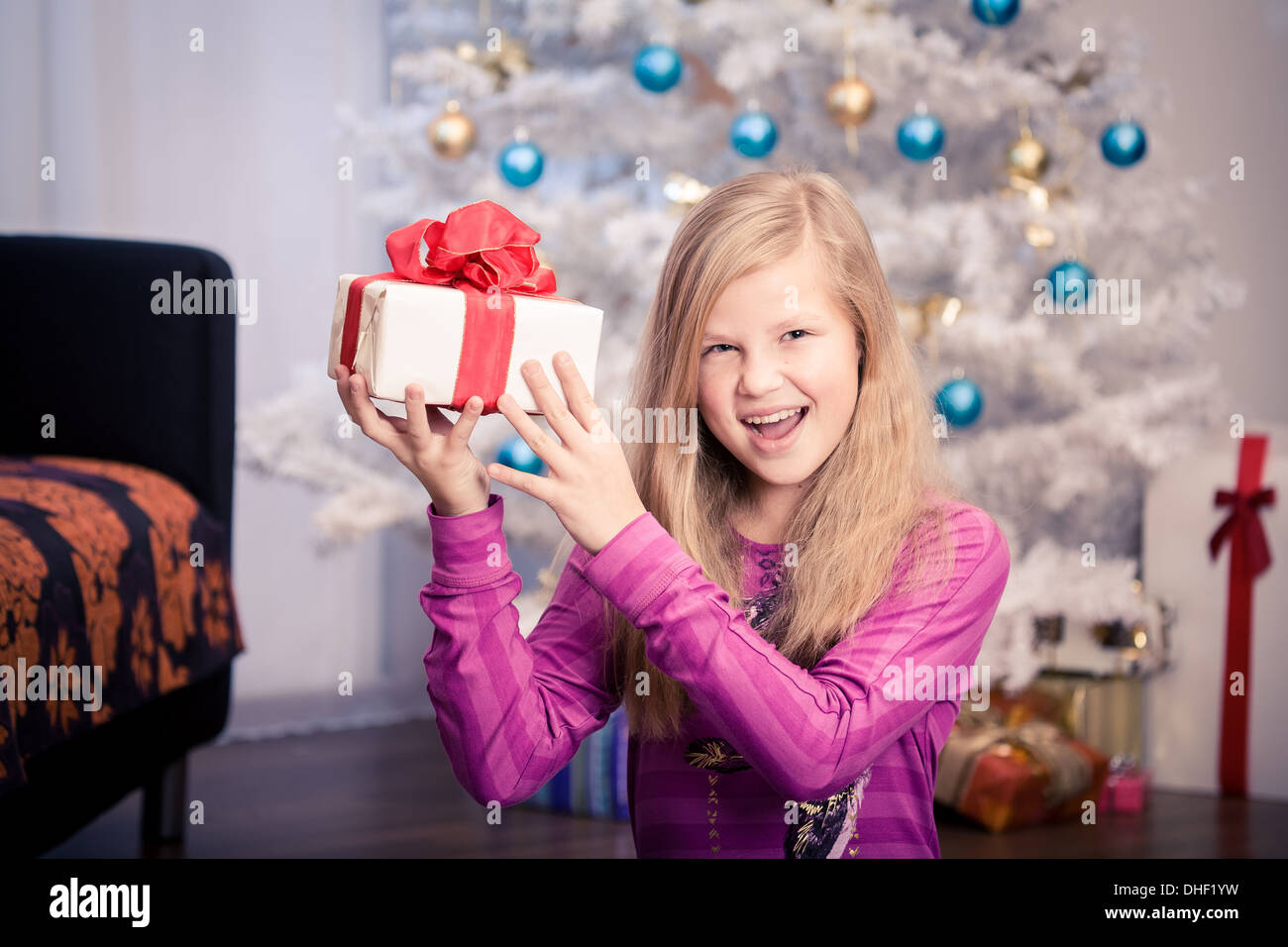 a little girl getting a Christmas gift Stock Photo - Alamy