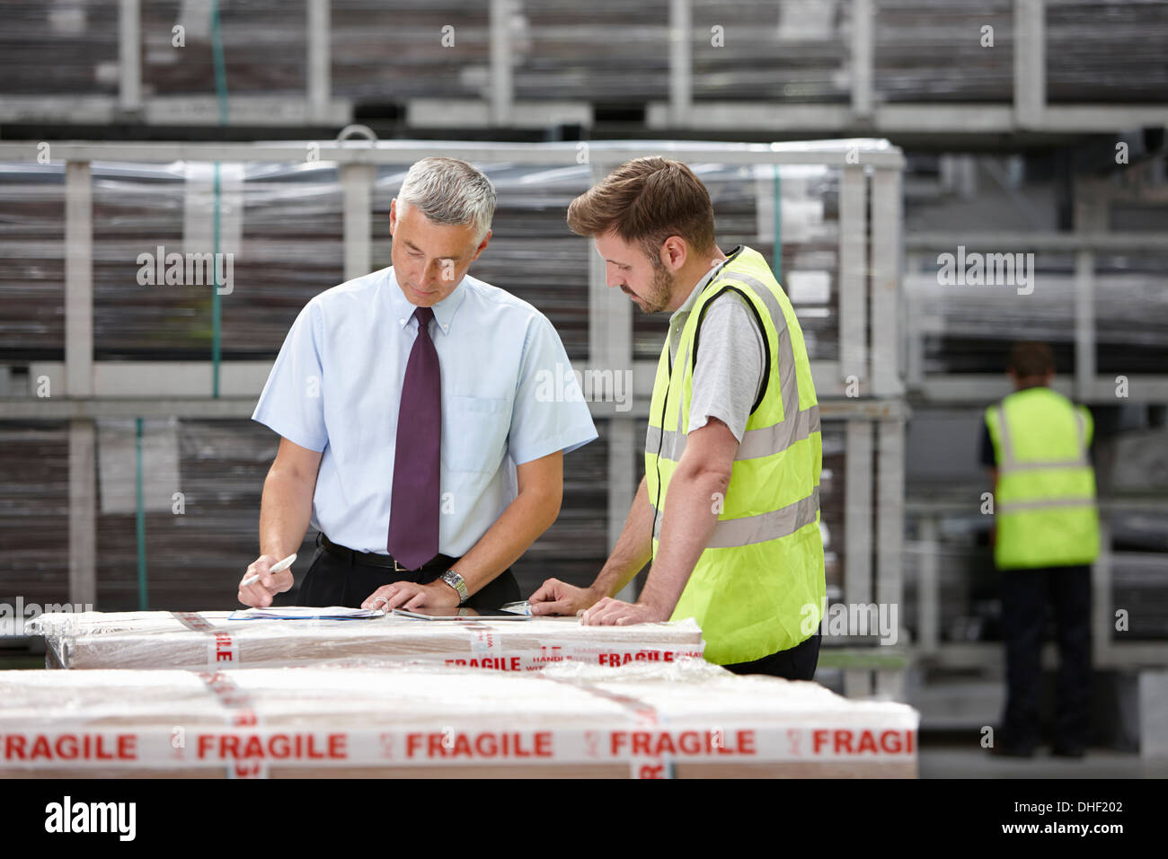 Warehouse worker and manager checking order in engineering warehouse ...