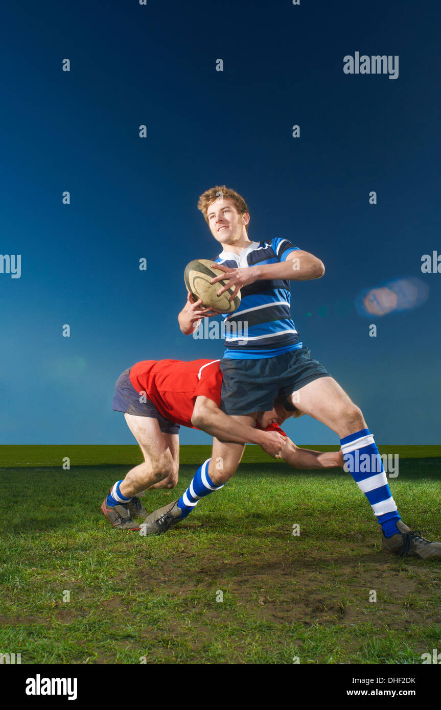 Young men playing rugby Stock Photo - Alamy