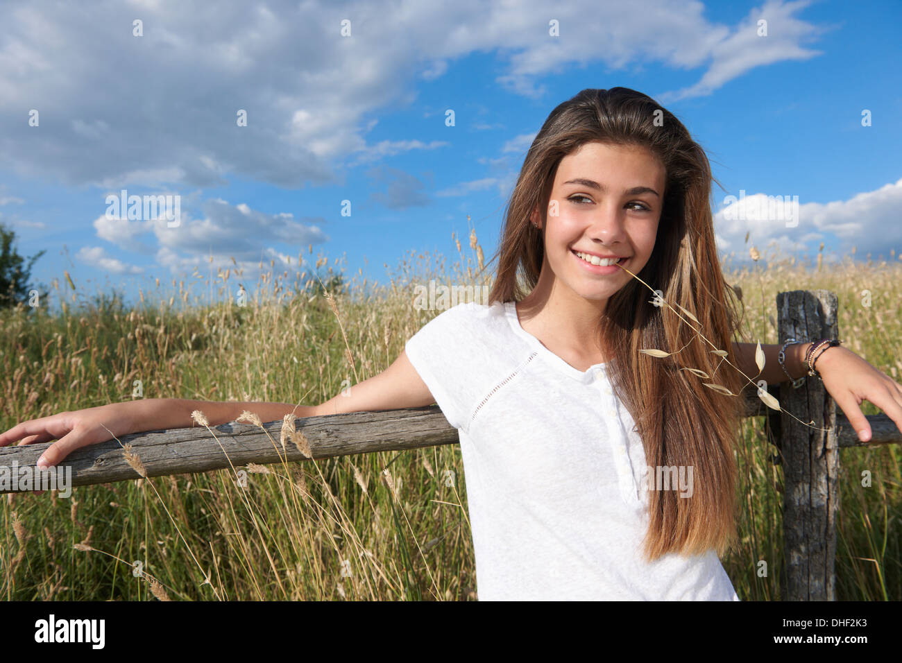 Teenage girl leaning on wooden fence, Tuscany, Italy Stock Photo - Alamy