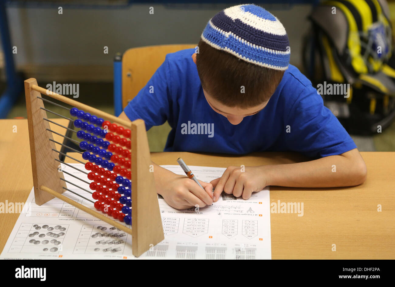 Berlin, Germany. 08th Nov, 2013. A child works out math problems at the ...