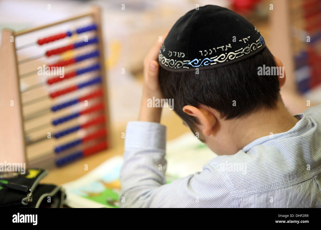Berlin, Germany. 08th Nov, 2013. A child works out math problems at the ...